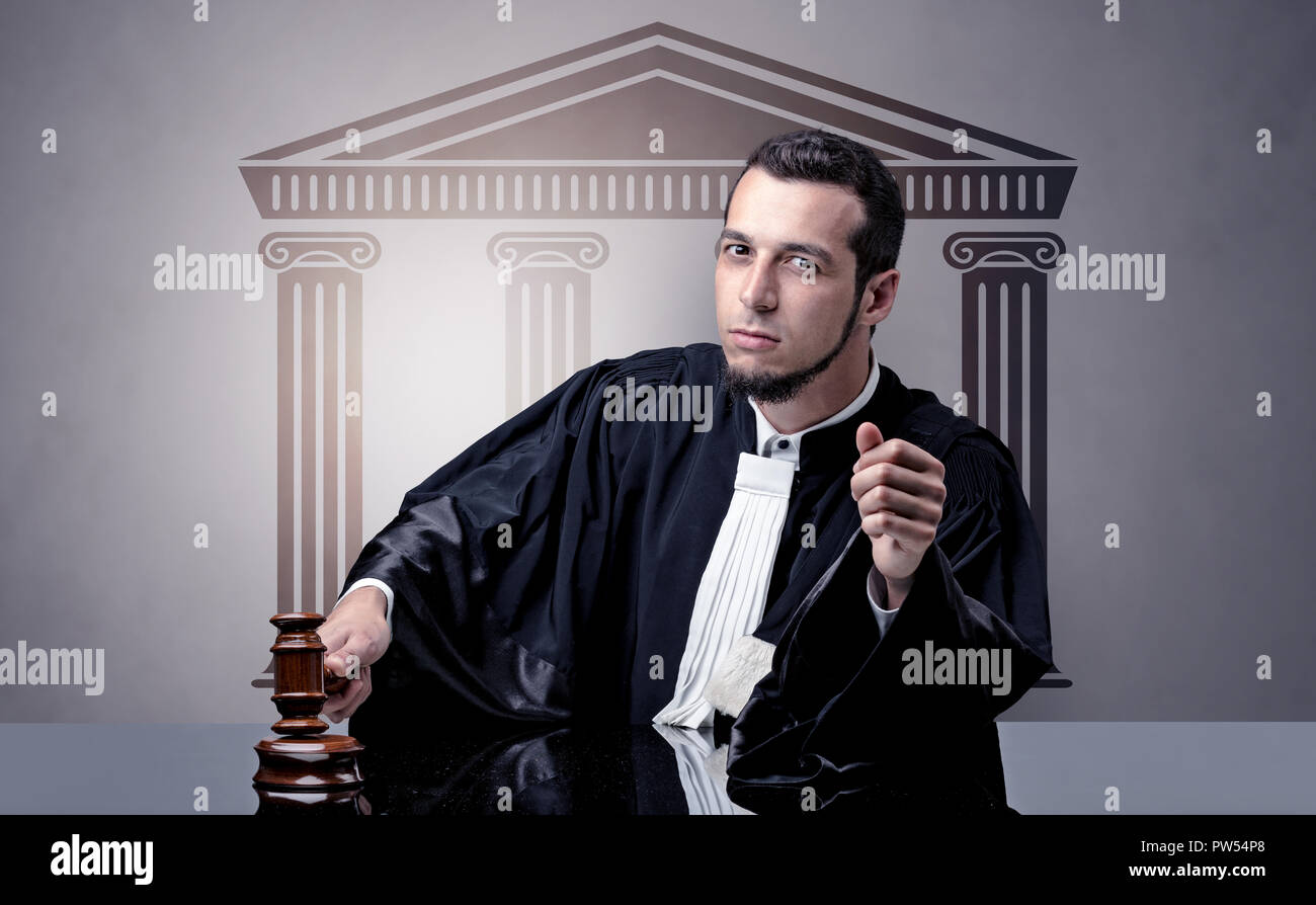 Young judge in front of a courthouse symbol making decision Stock Photo ...