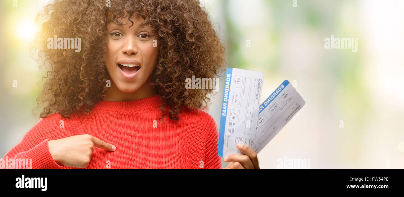 African american woman holding airline boarding pass tickets with ...