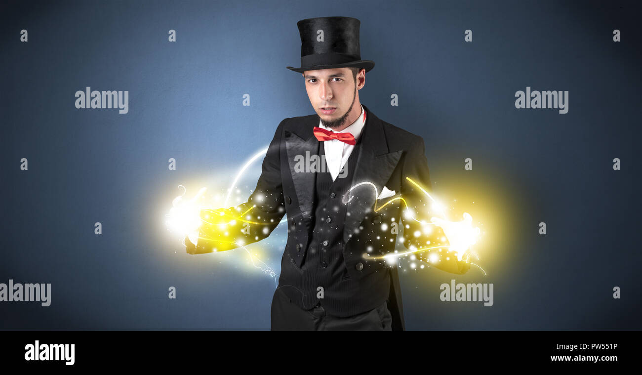 Magician holding his sparkling power between his two hand Stock Photo ...