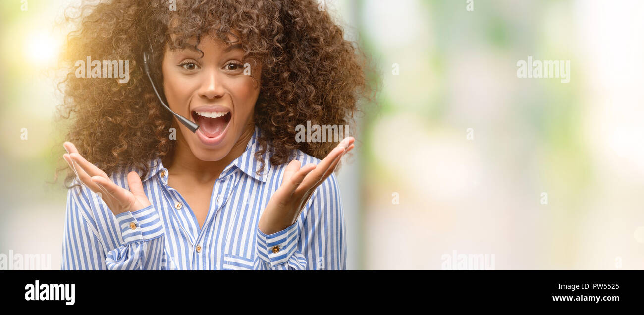 African american call center operator woman very happy and excited ...