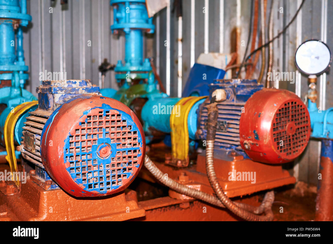 Old electric motor to the pump, valve and pressure gauge on the ...