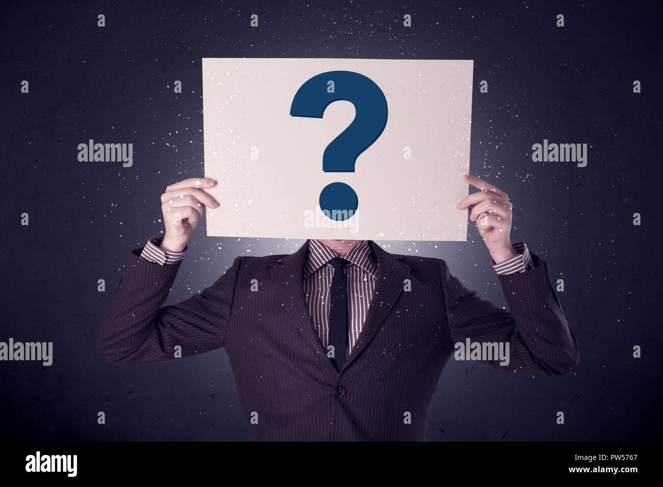 Young businessman hiding behind a question mark drawn on paper Stock ...
