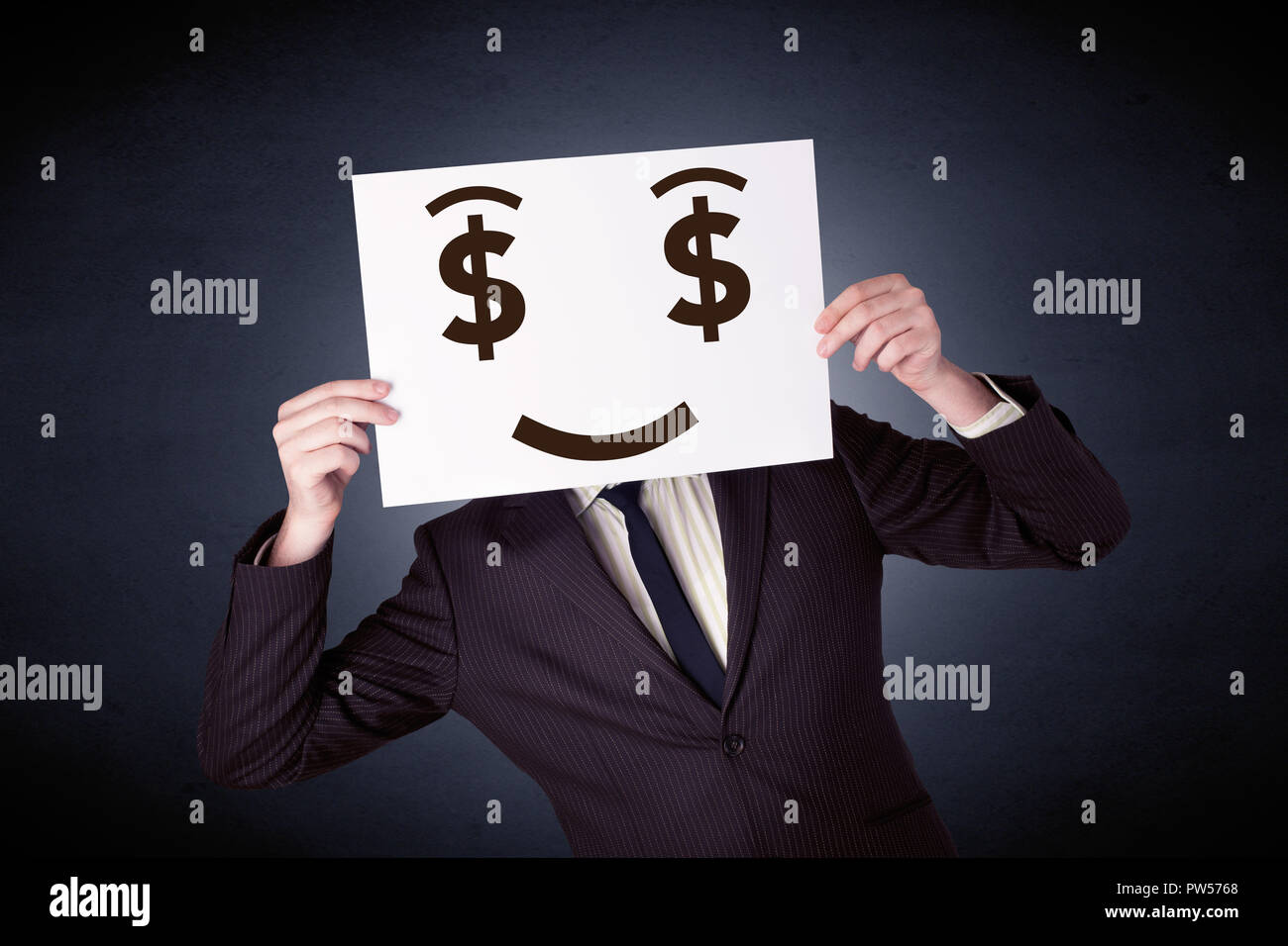 Young casual businessman hiding behind a greedy face drawing on ...