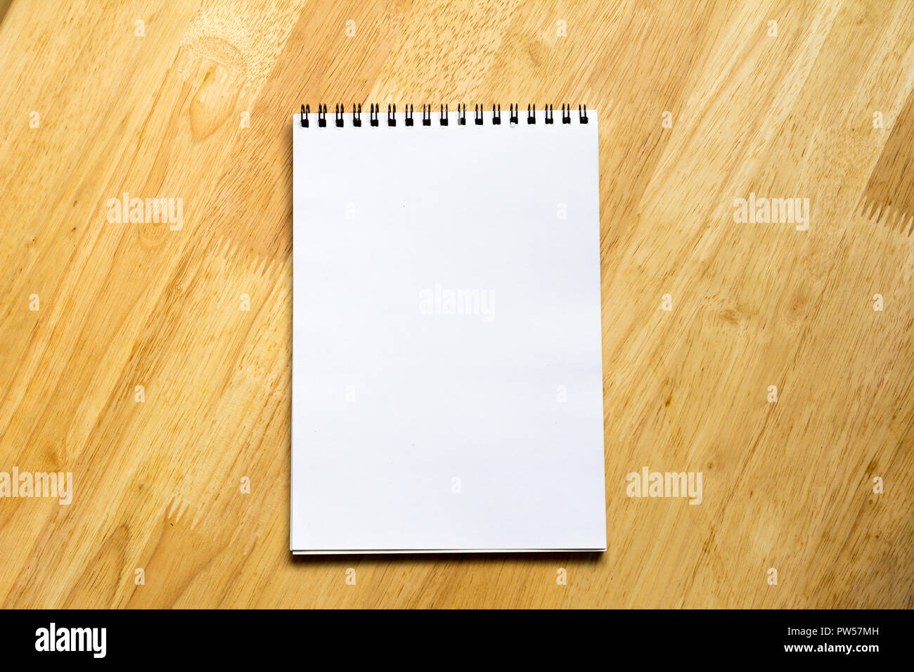White note book place on wooden table background Stock Photo - Alamy