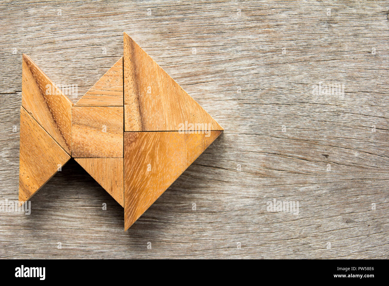 Chinese tangram puzzle in fish shape on wooden background Stock Photo ...
