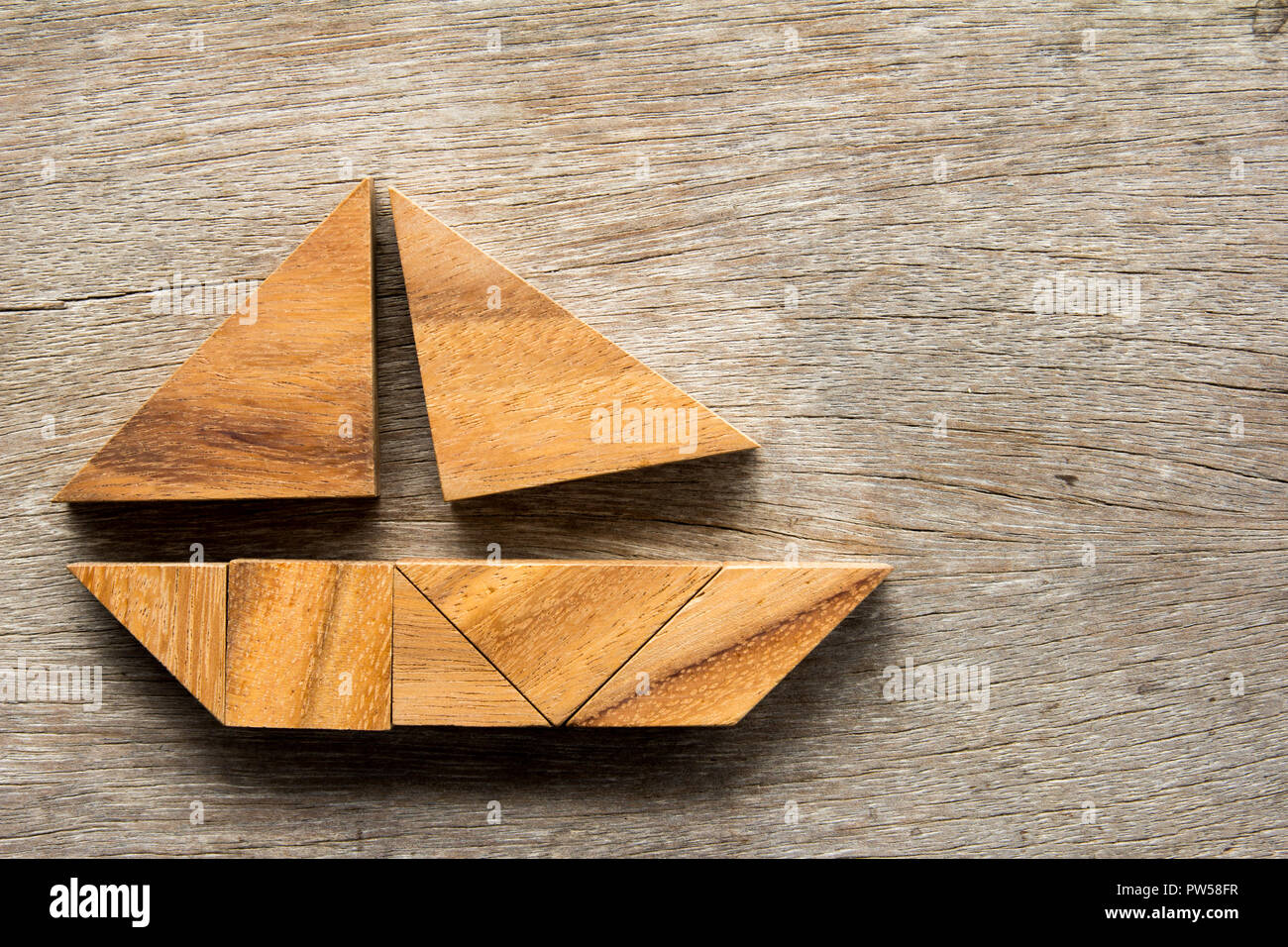 Tangram puzzle in sail boat shape on wooden background Stock Photo - Alamy