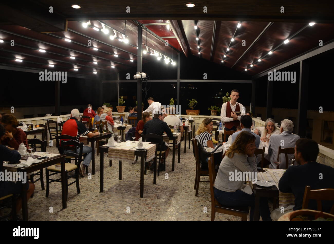 the roof terrace of Restaurant Mangalemi with diners and waiters Stock ...