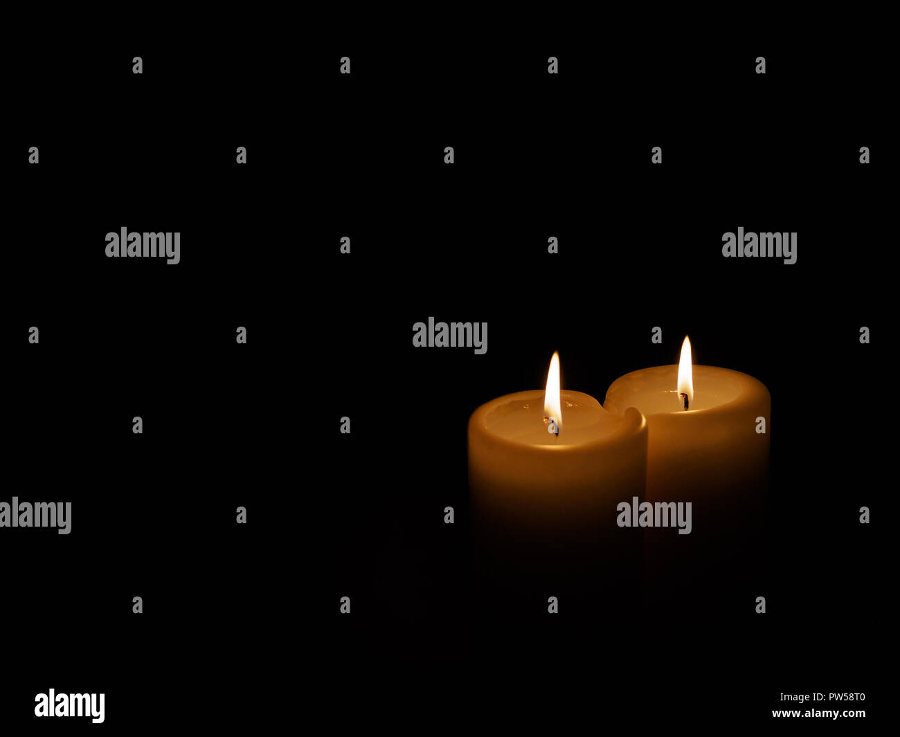 Two candles in the dark Stock Photo - Alamy