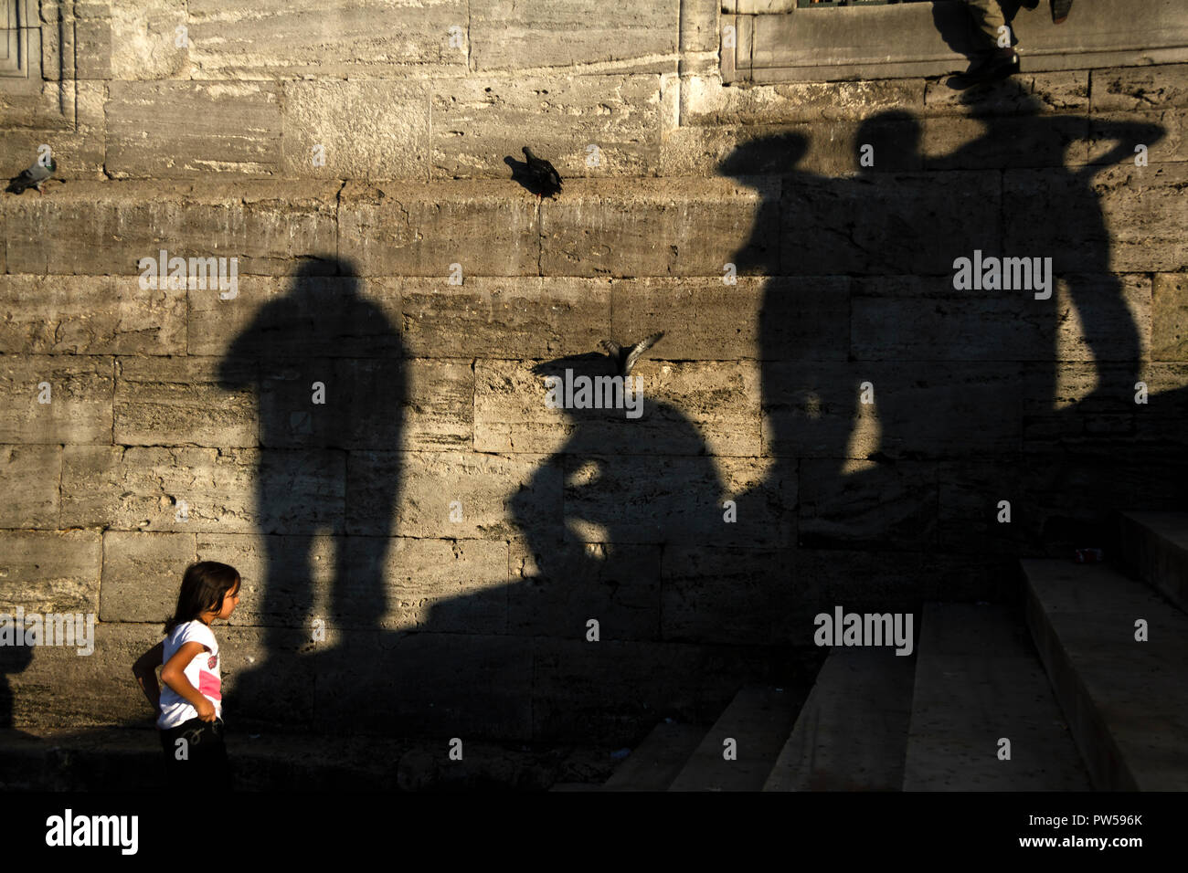 Crowd walking in shadow hi-res stock photography and images - Alamy