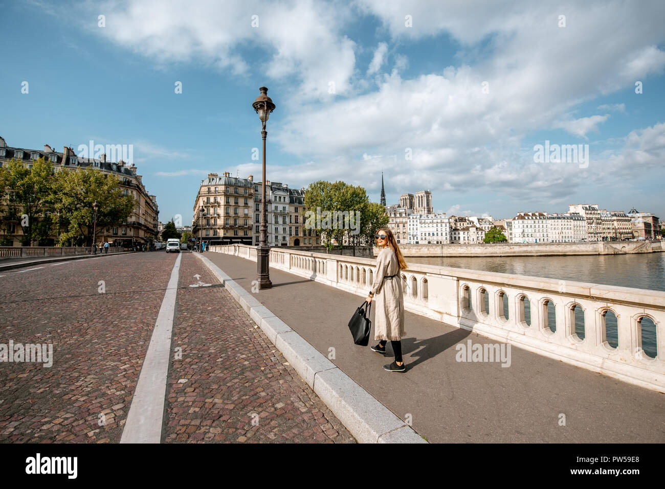 Morning street view with stylish woman walking the street in Paris ...
