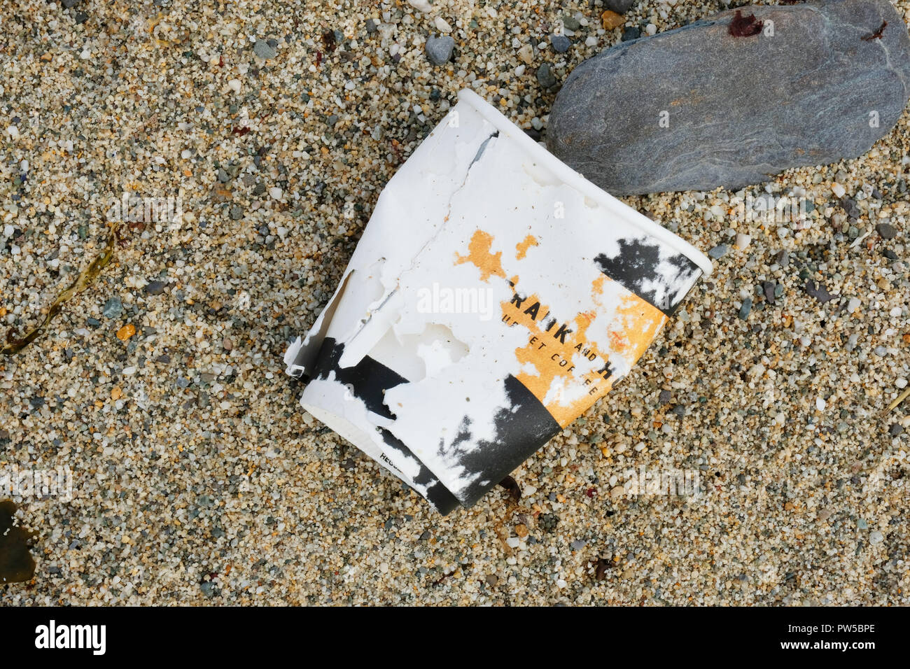 Crushed disposable coffee cup lying on a sandy beach - John Gollop ...