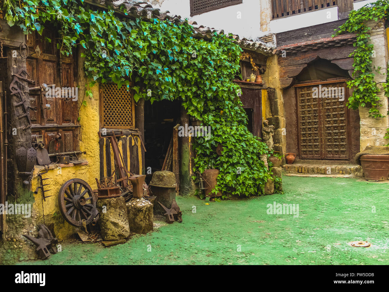 Rural Workshop with many tools used in agriculture: anvil, wheel ...