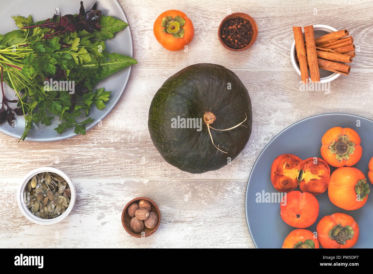Green Pumpkin, persimmons and ingredients for tasty vegetarian cooking ...