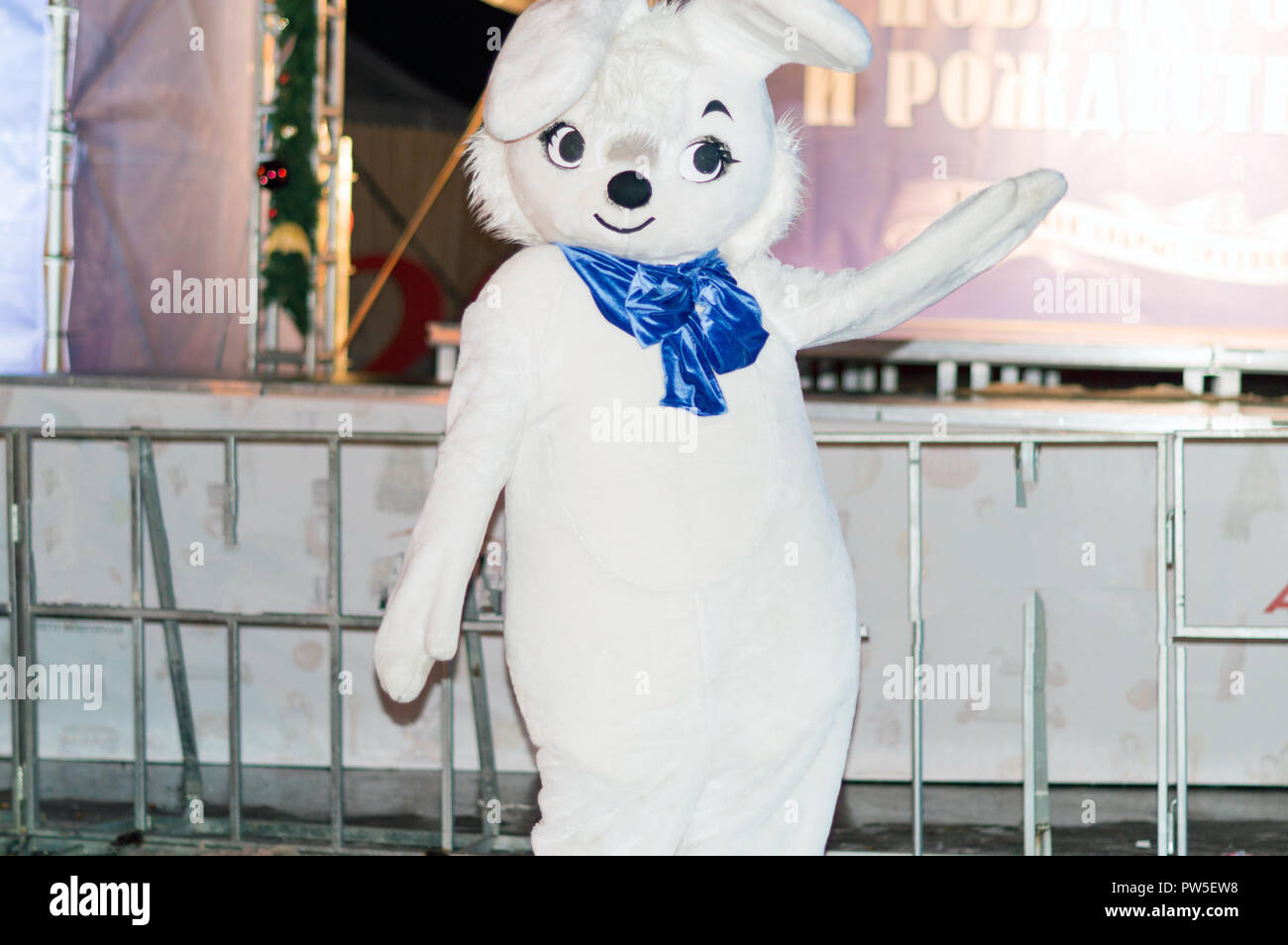 A young man in the costume of a white, fluffy hare stands near the New ...