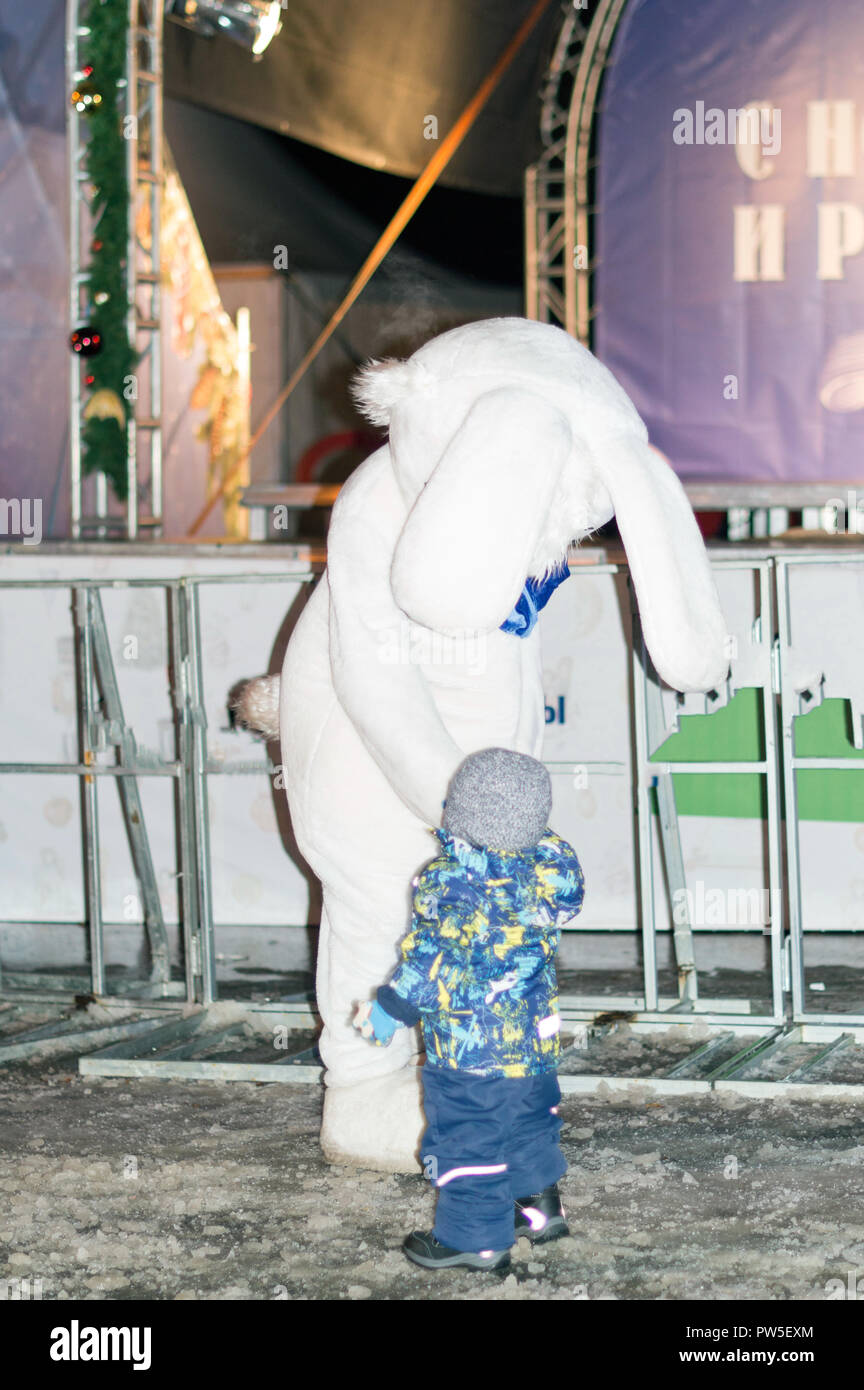 A young man in the costume of a white, fluffy hare stands near the New ...