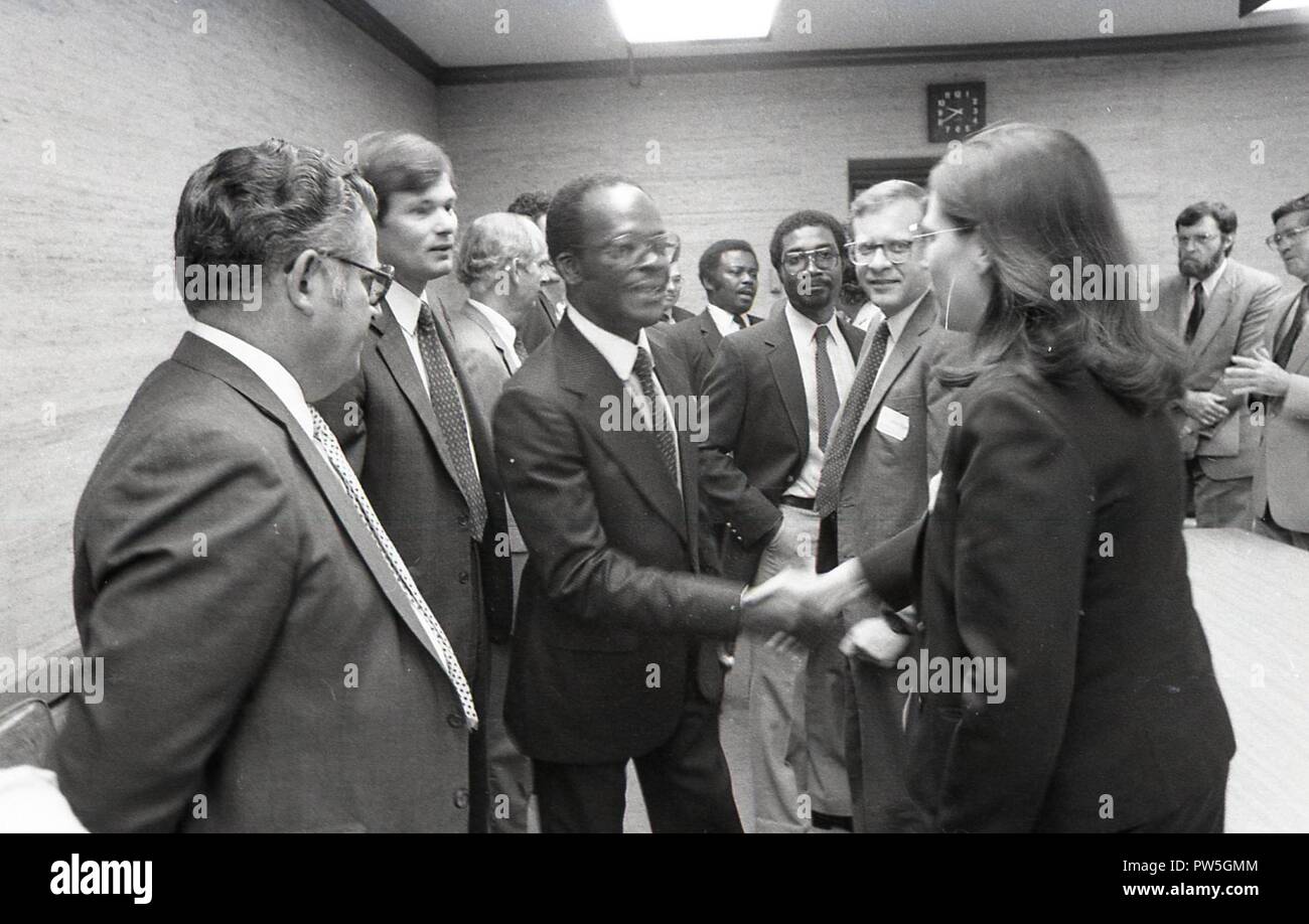 Snapshot of people standing in a room, conversing Stock Photo - Alamy