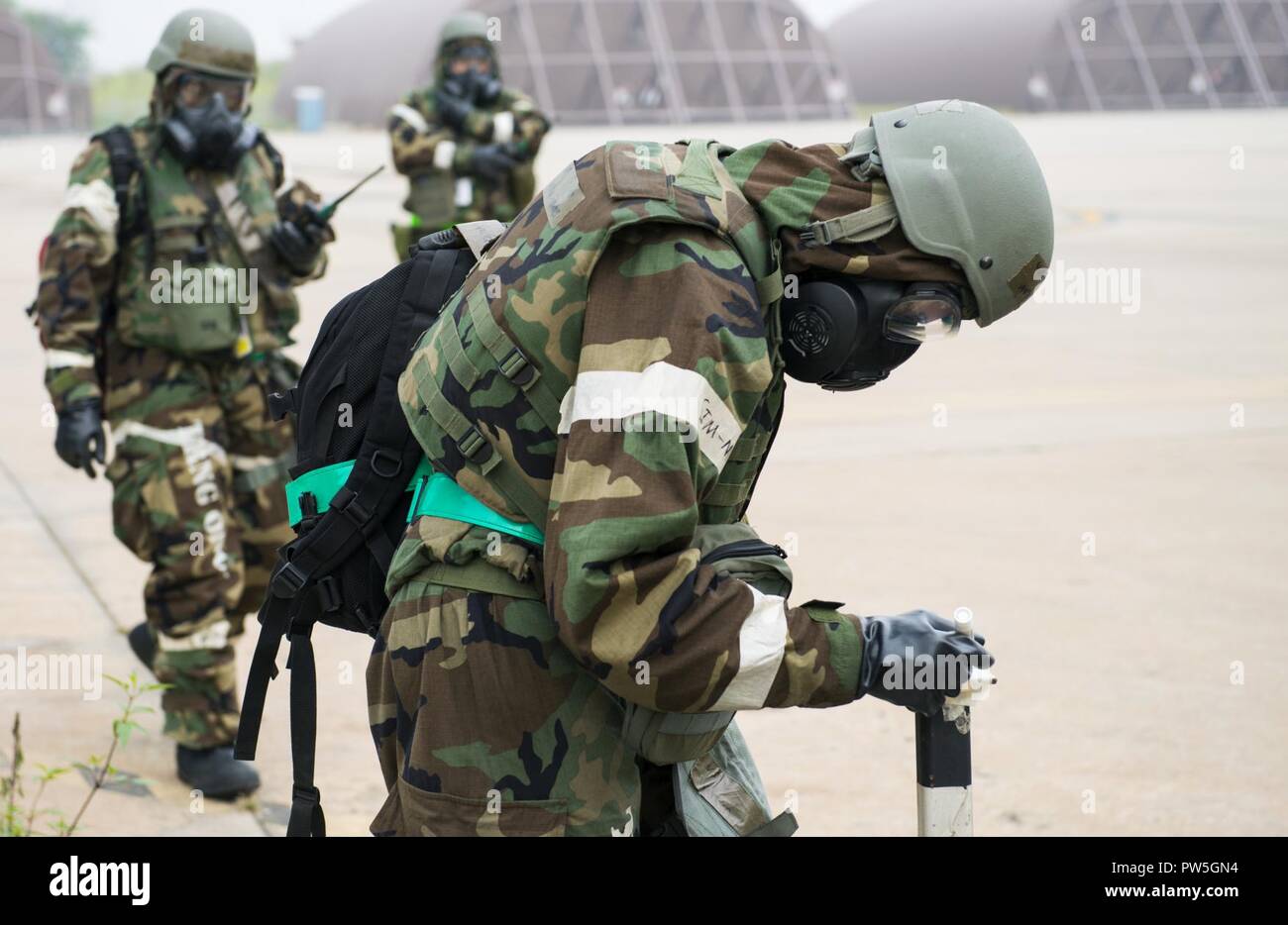 A U.S. Air Force Post Attack Reconnaissance Team member checks M-8 ...