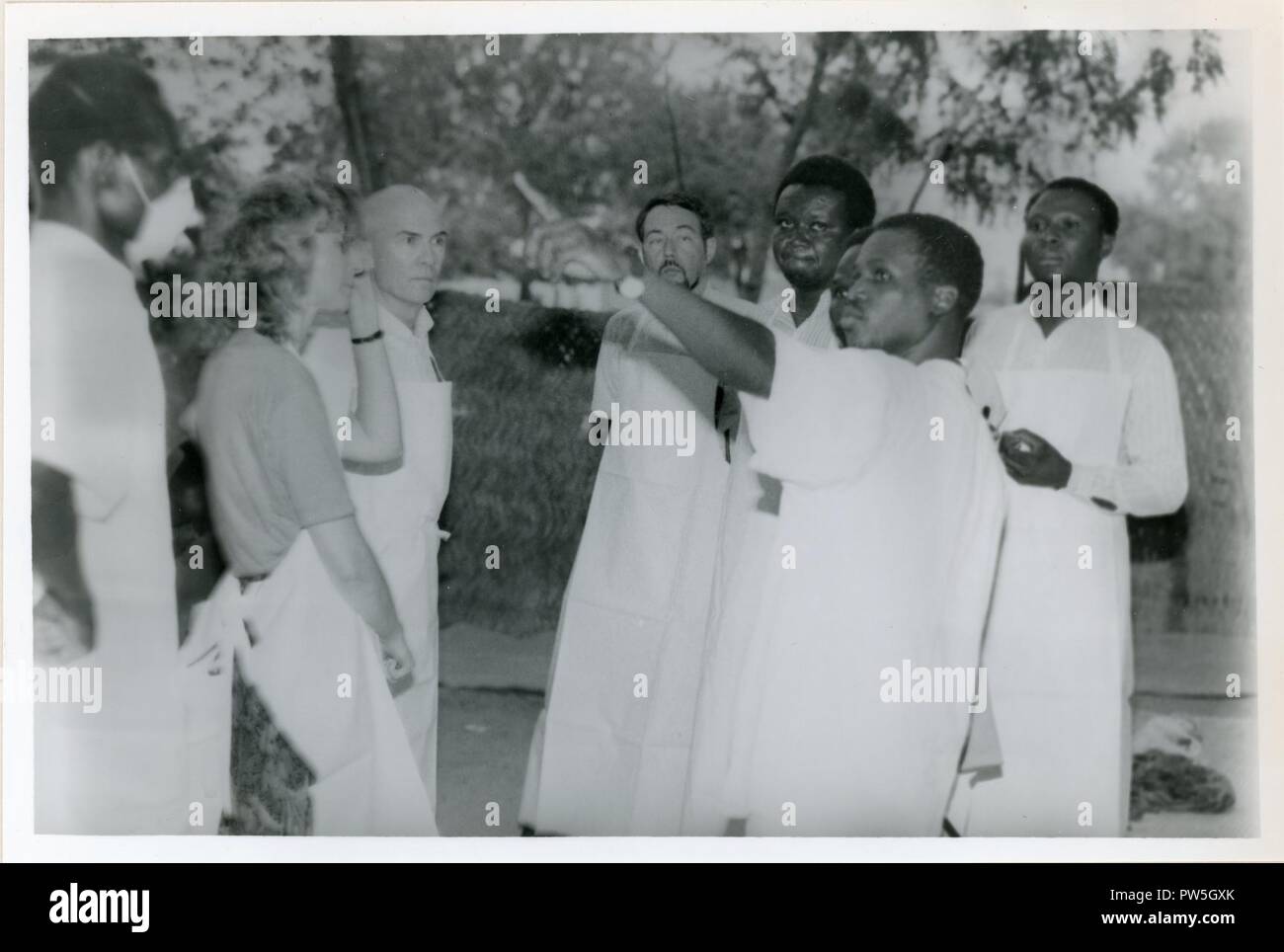 Black and white snapshot of people gathered around, talking Stock Photo ...