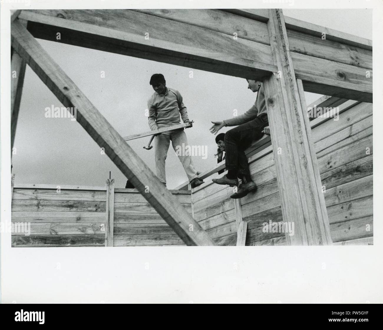 Snapshot of men laying wood for a building structure Stock Photo - Alamy
