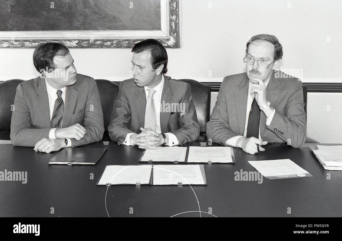 Black and white photo of three men sitting at a table Stock Photo - Alamy