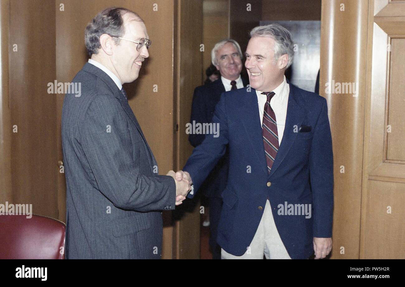 TWO MEN GREETING EACH OTHER WITH A HAND SHACK Stock Photo - Alamy