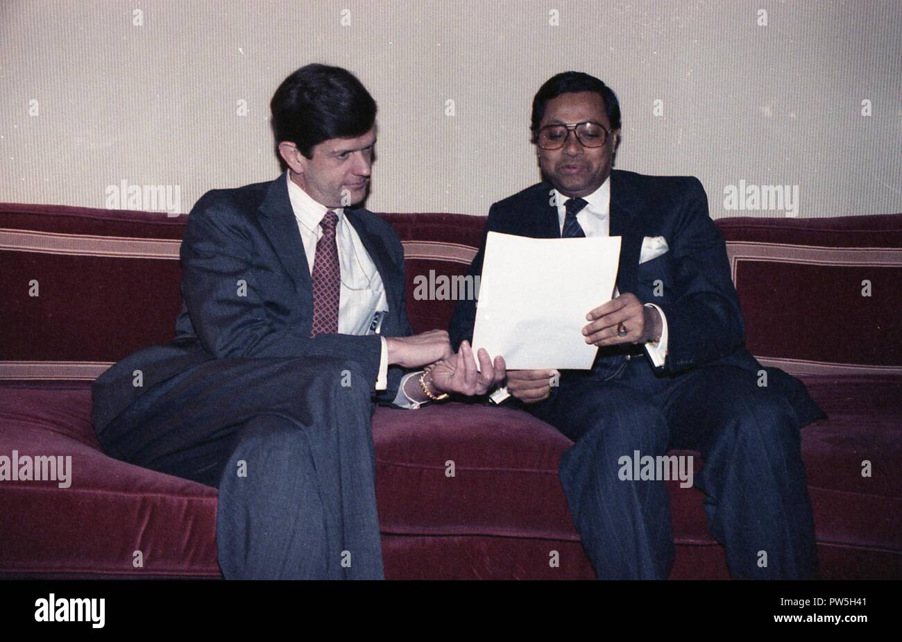 TWO MEN LOOKING OVER SOME PAPERS Stock Photo - Alamy