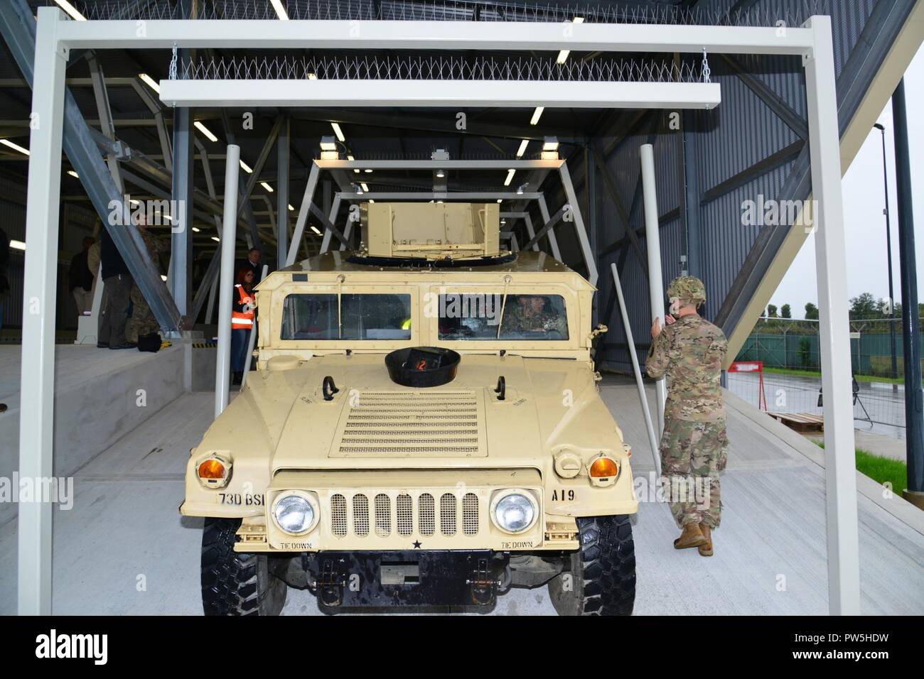 A High Mobility Multipurpose Wheeled Vehicle (HMMWV) is loaded into a C ...