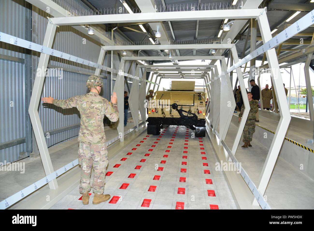 A High Mobility Multipurpose Wheeled Vehicle (HMMWV) is loaded into a C ...