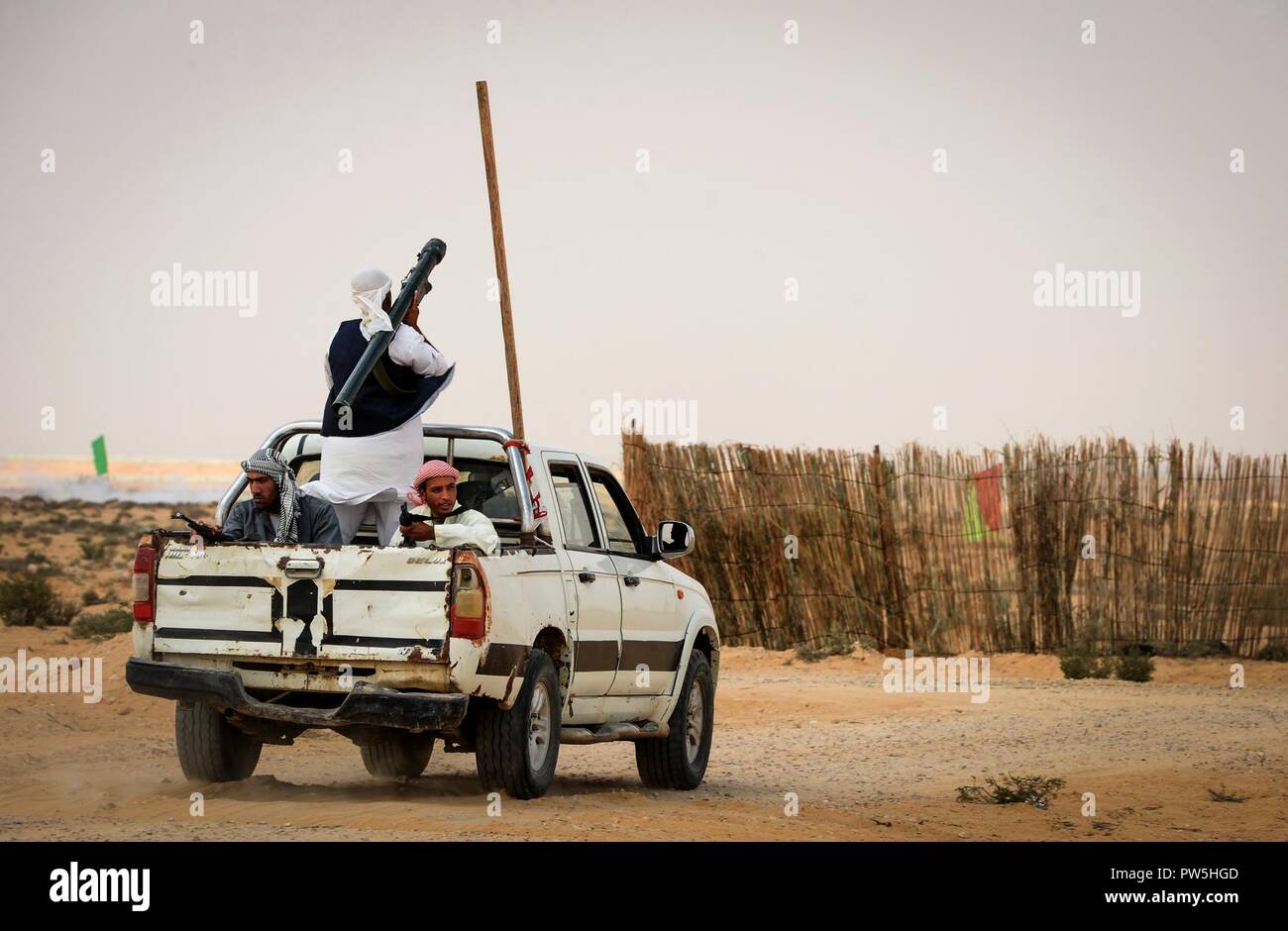 Three Egyptian soldiers role play as enemy combatants during an ...