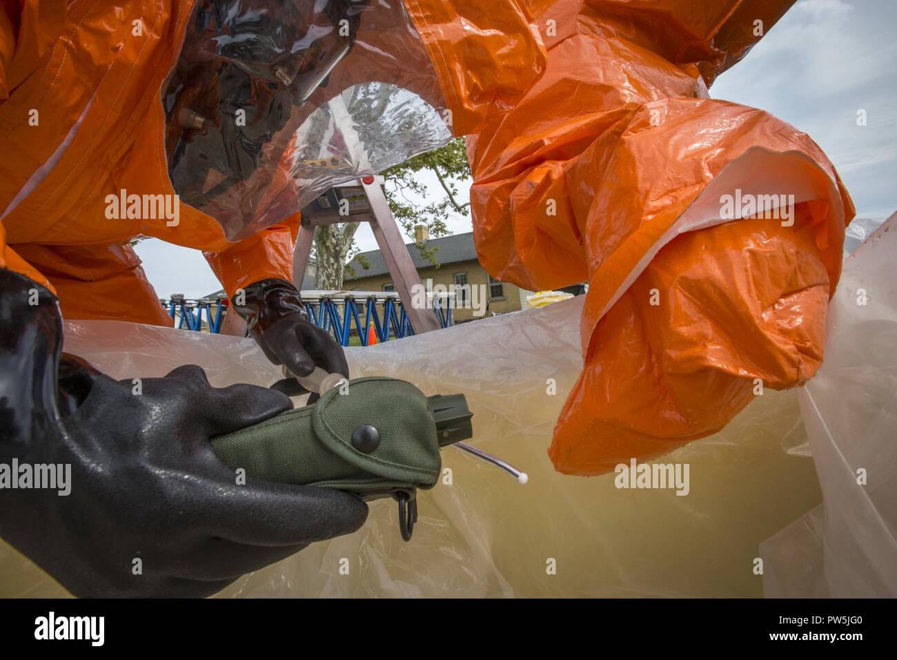 U.S. Army Staff Sgt. Kenneth Williams, left, uses a handheld volatile ...