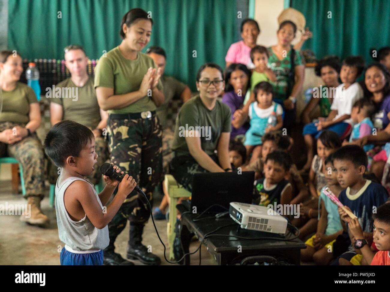 A Filipino boy sings a song during a cooperative health engagement ...