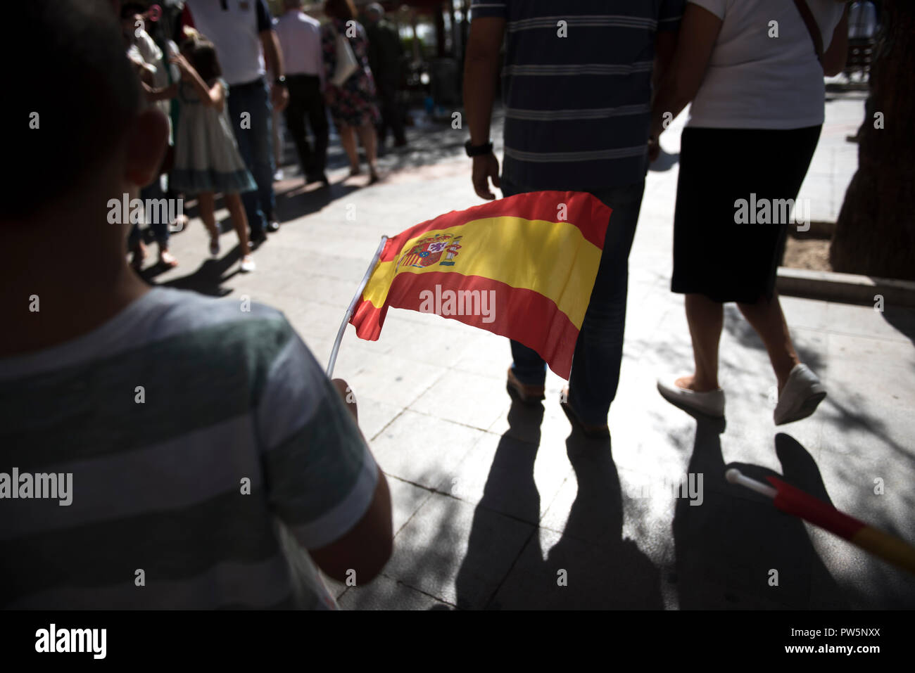 A kid seen waving a Spanish flag after the National Day parade in ...