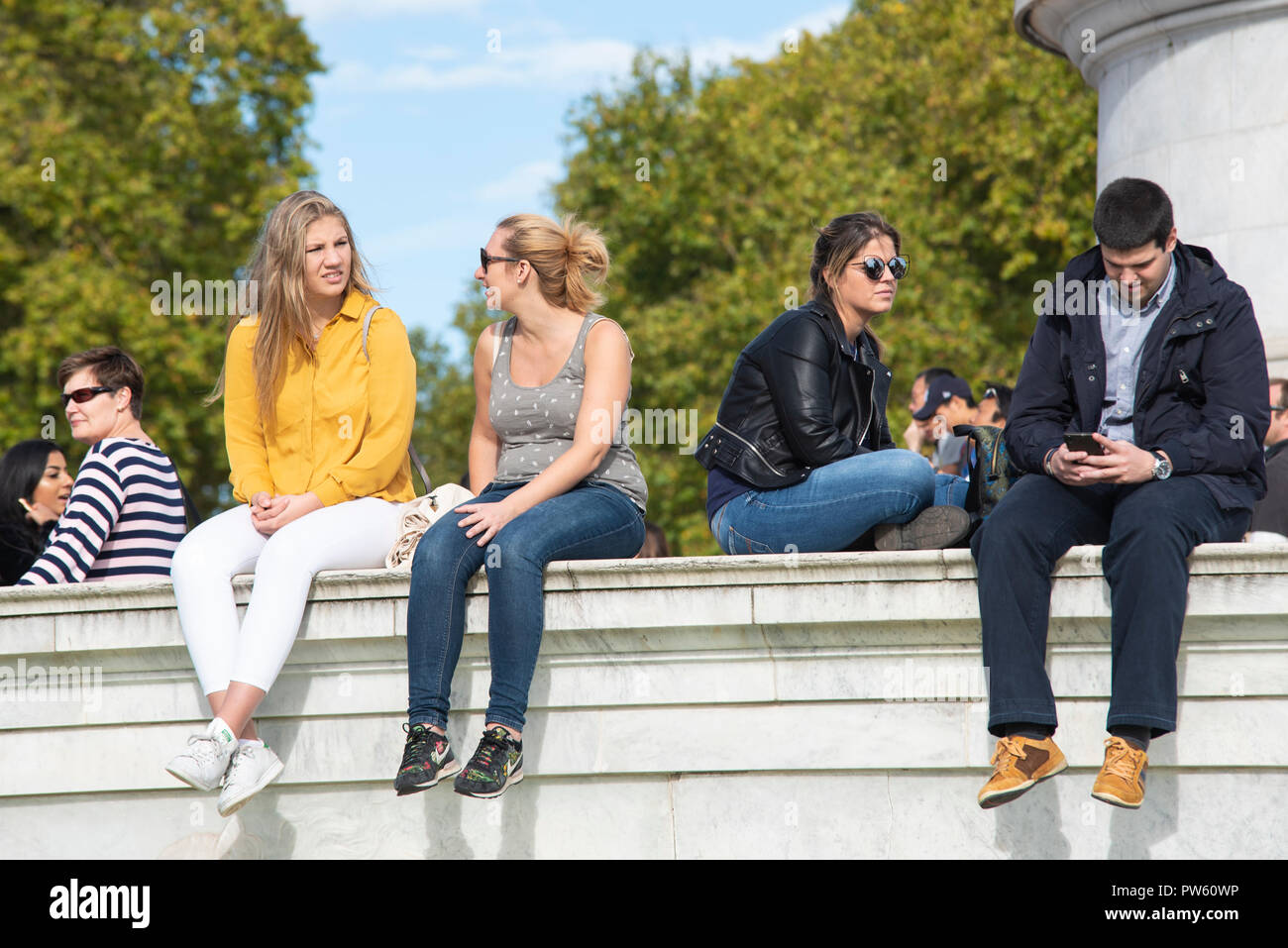 Tourists enjoying the sunny warm Autumn weather in London, UK. People ...