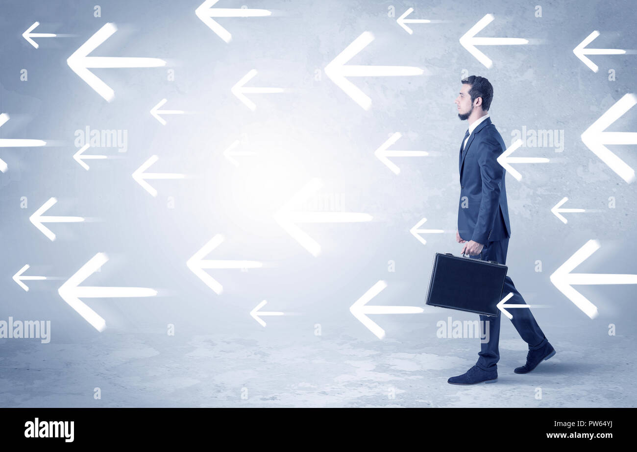 Businessman walking with arrows on the background and briefcase on his ...