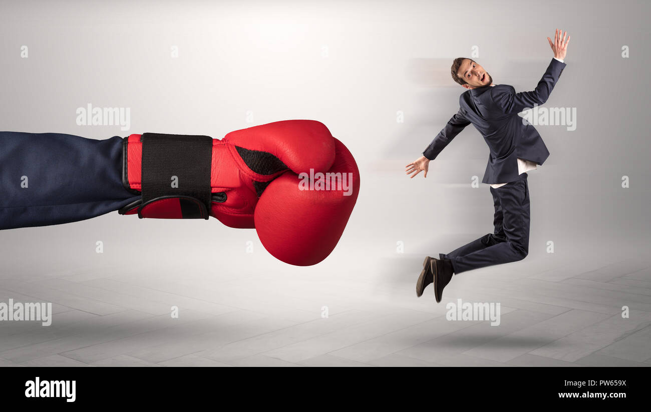 Giant hand gives a kick to a small employee businessman Stock Photo - Alamy