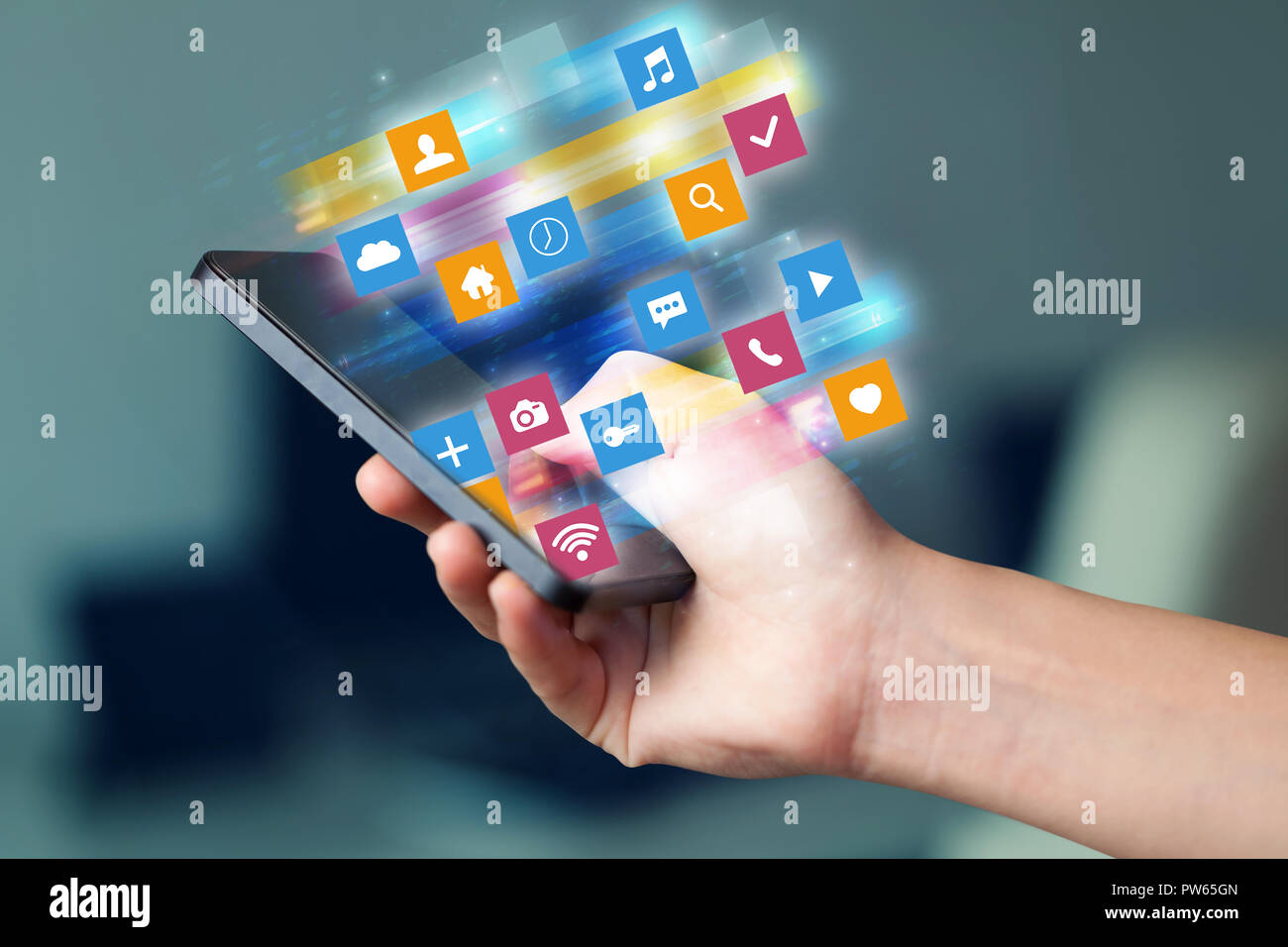 Hand using phone with colorful fast moving application icons and ...