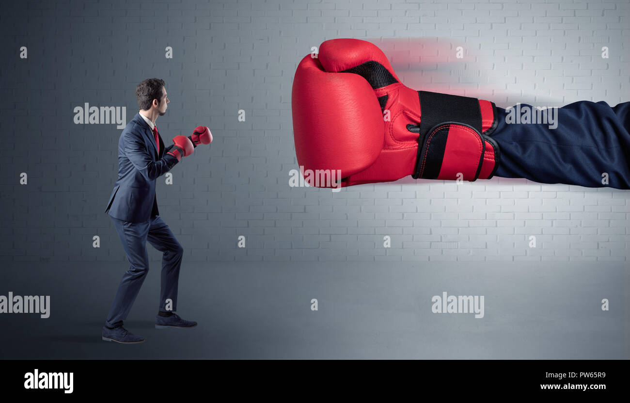 Tiny businessman fighting with boxing gloves Stock Photo - Alamy