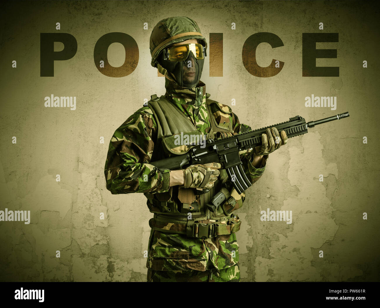 Uniformed armed soldier with damaged wall background Stock Photo - Alamy