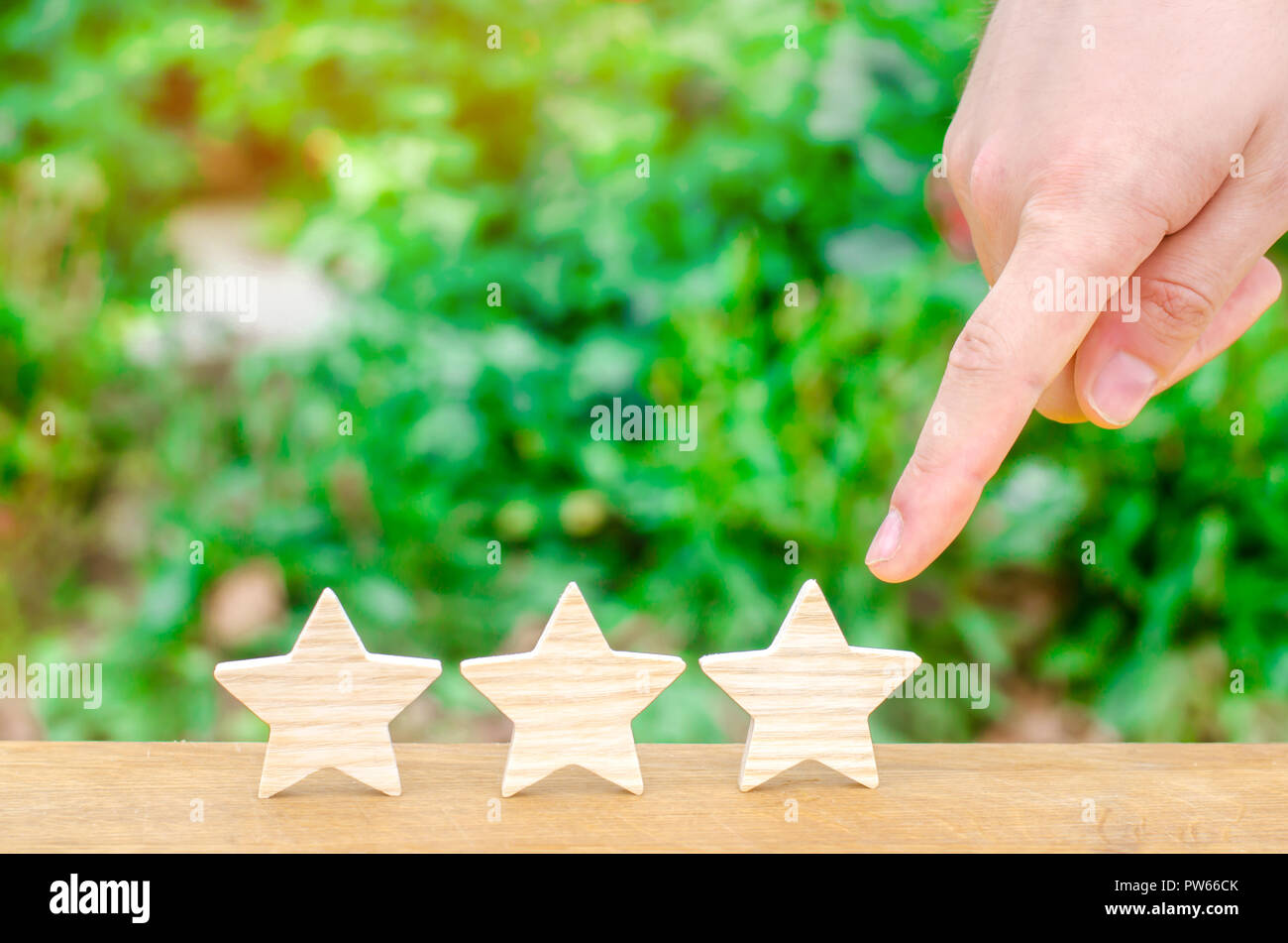 The hand points to the third star on a green background. Rating, level ...
