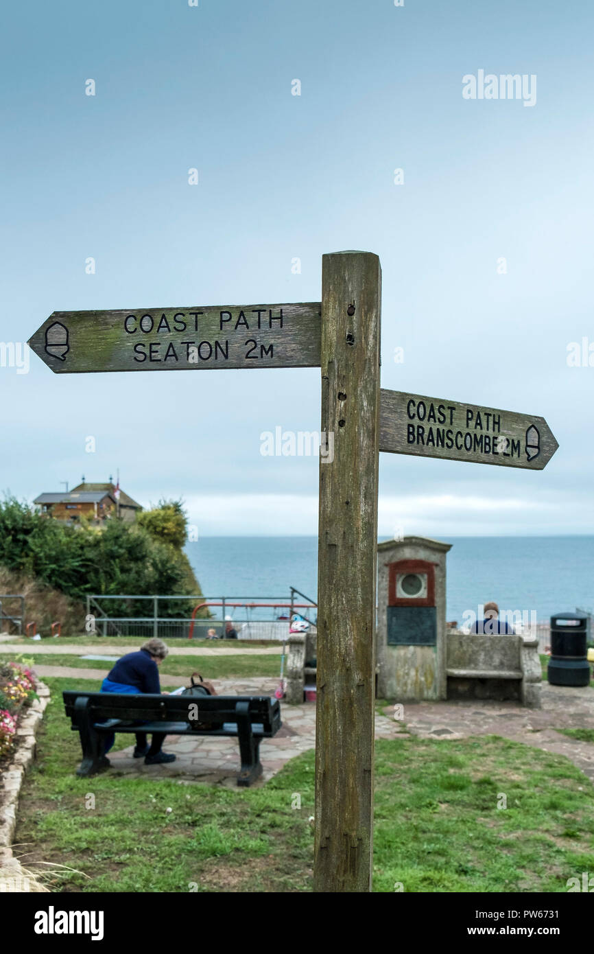 A wooden sign post for the coast path in Beer Village in Devon Stock ...