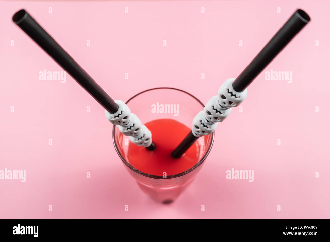 Halloween cocktail straws in glass full of fake blood Stock Photo - Alamy