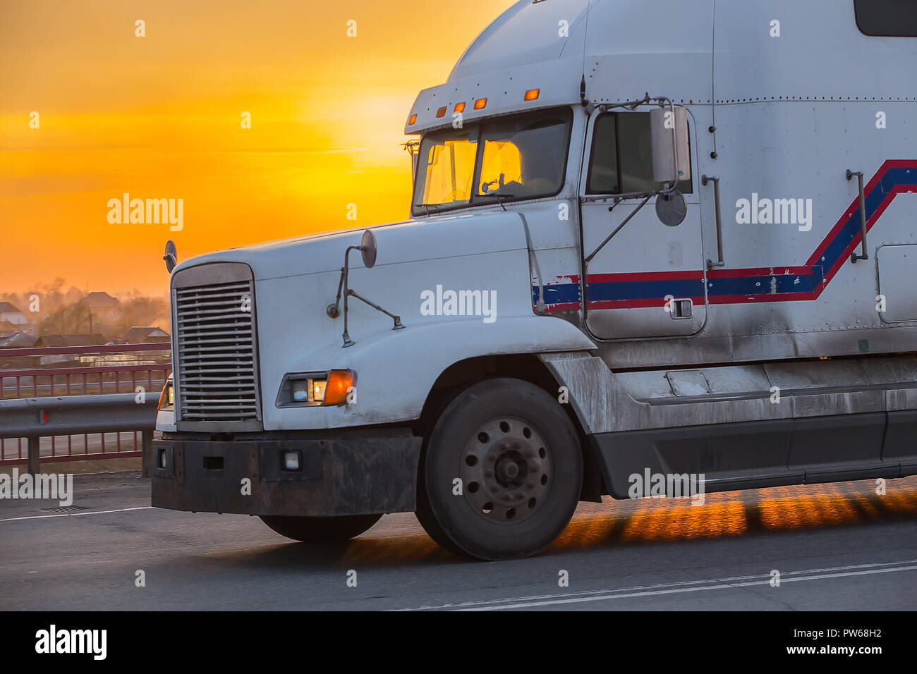 truck goes on highway in evening on sunset Stock Photo - Alamy