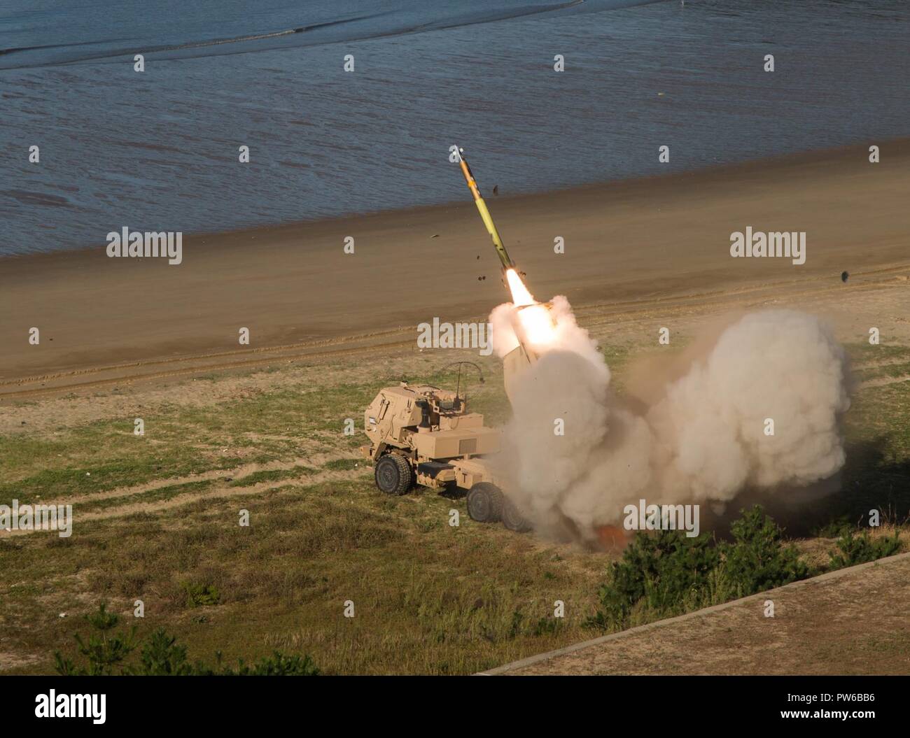 U.S. Soldiers launch rockets from an M142 High Mobility Artillery ...