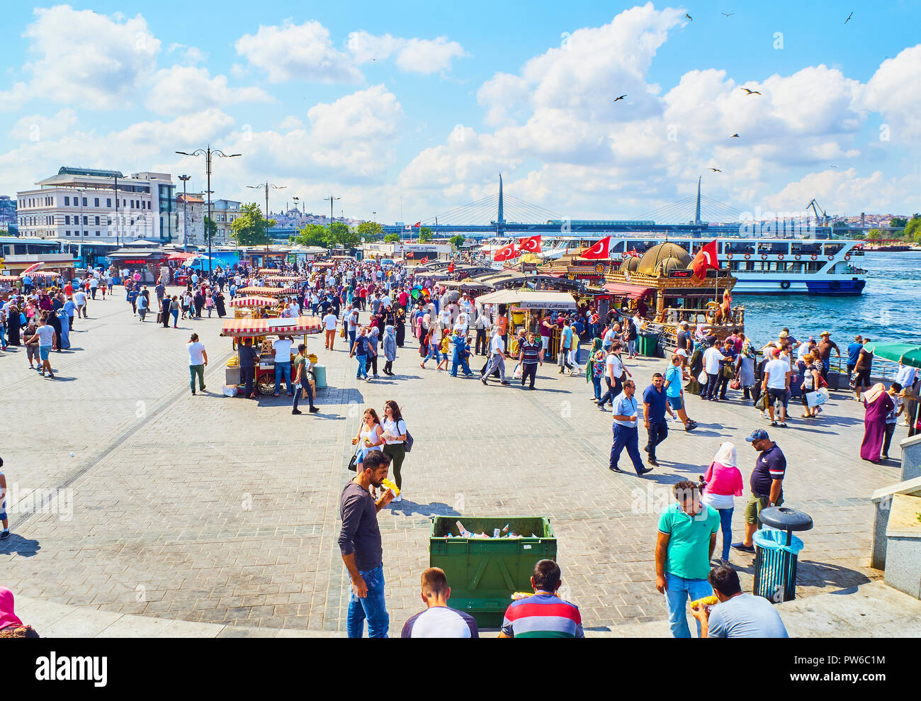 Istanbul, Turkey - July 11, 2018. Tourists visiting the Eminonu Pier at ...