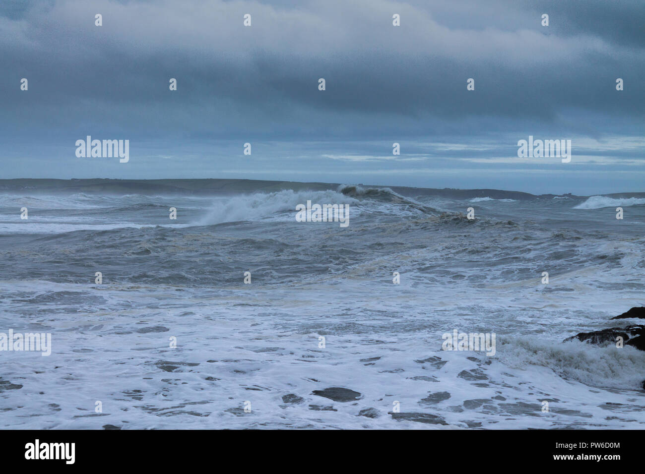 huge white capped waves rolling in from the atlantic ocean under a ...