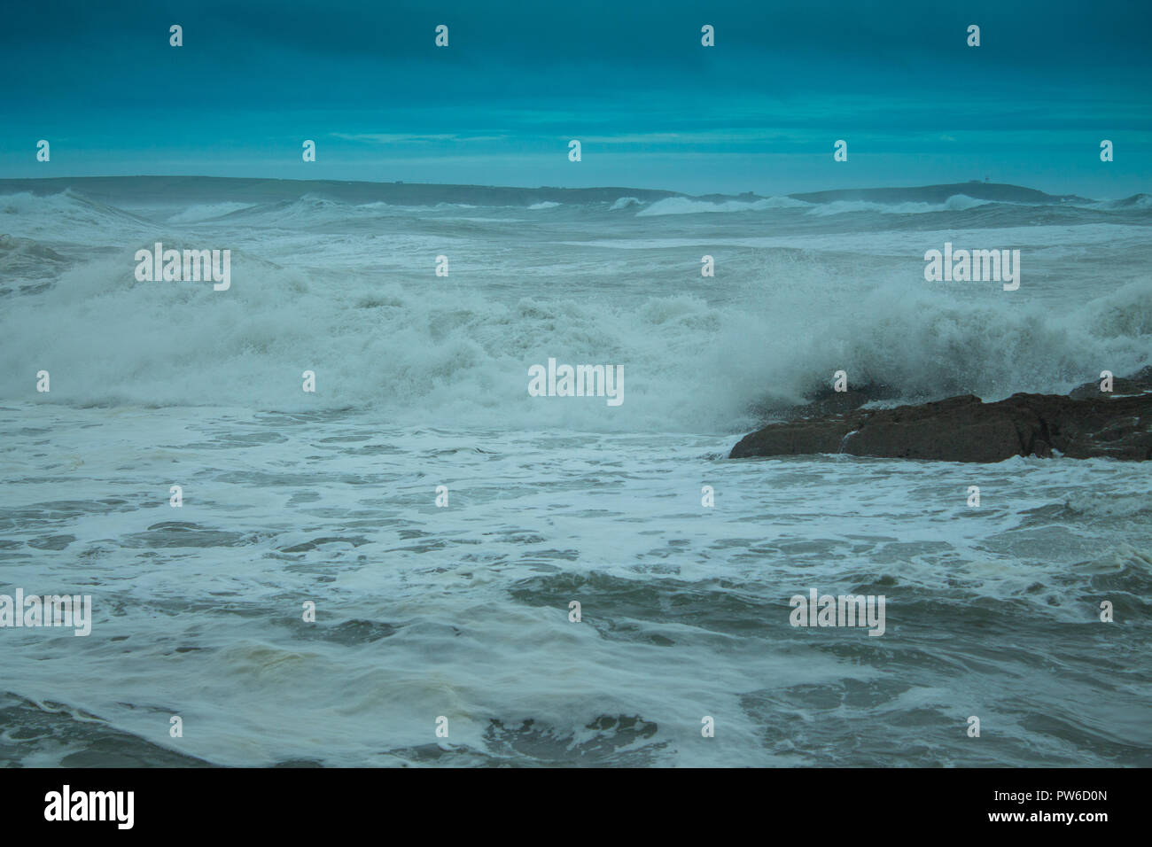 huge white capped waves rolling in from the atlantic ocean under a ...