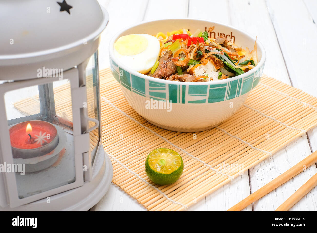 Malay Mee Rebus in the bowl with chopsticks on white table This dish is ...