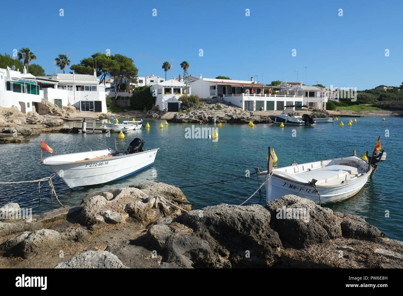 Small boats tied up in the harbour of Biniancolla, Menorca, Spain Stock ...