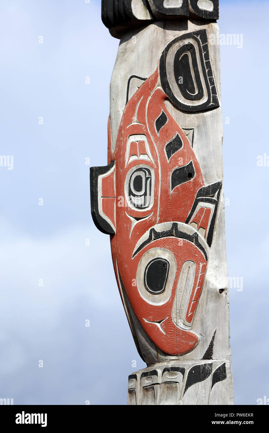 Native American salmon motif totem pole with red background Stock Photo ...