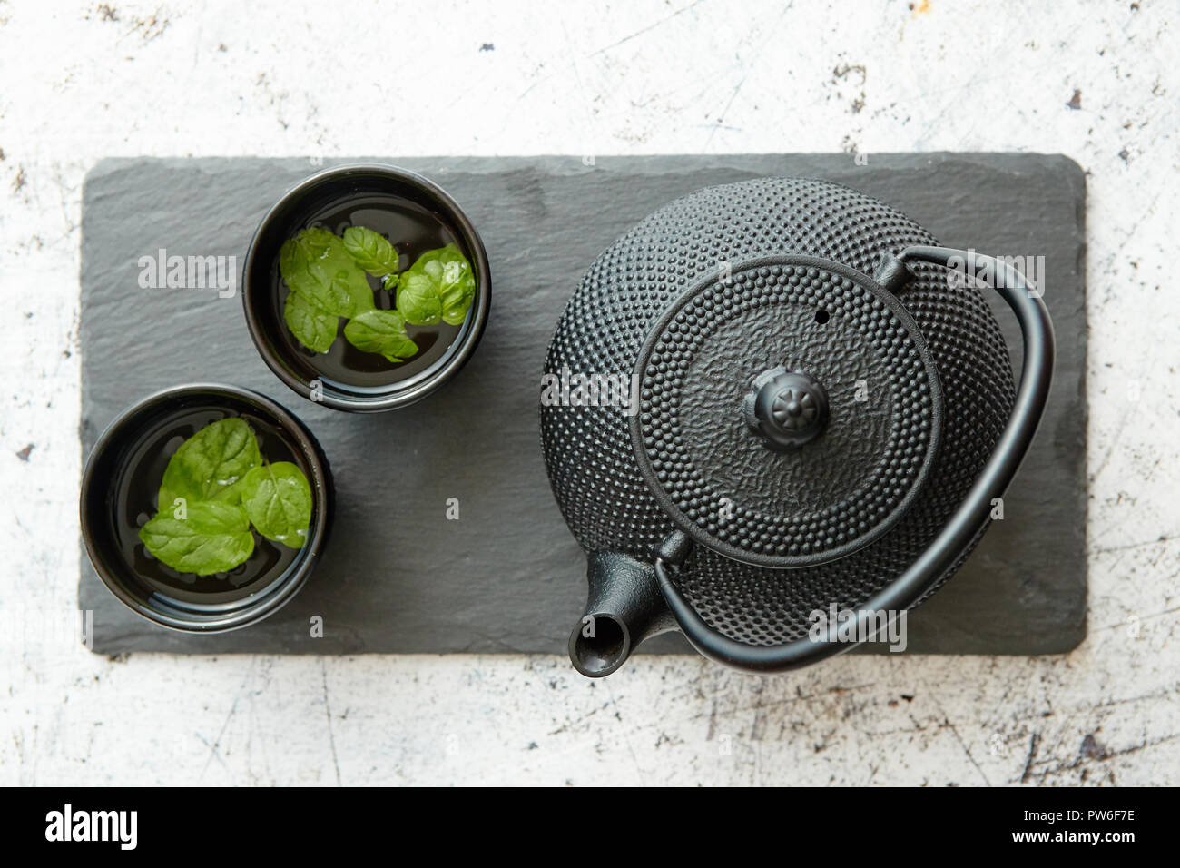 Traditional eastern metal teapot and iron cups Stock Photo - Alamy